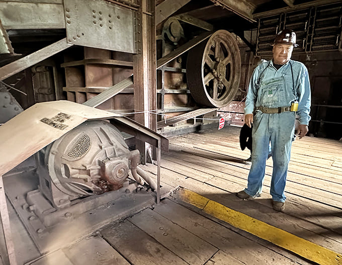 Living history: A mine worker demonstrates equipment that helped extract millions of tons of high-grade ore from Minnesota's iron range.
