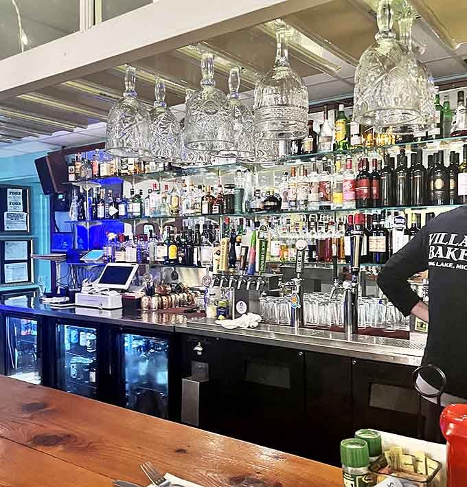 Crystal decanters gleam above a meticulously organized bar &ndash; liquid treasures waiting to be transformed into handcrafted cocktails.