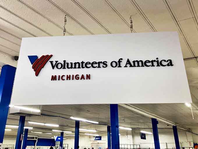 The Volunteers of America Michigan sign stands as a reminder that every purchase helps fund vital community programs.