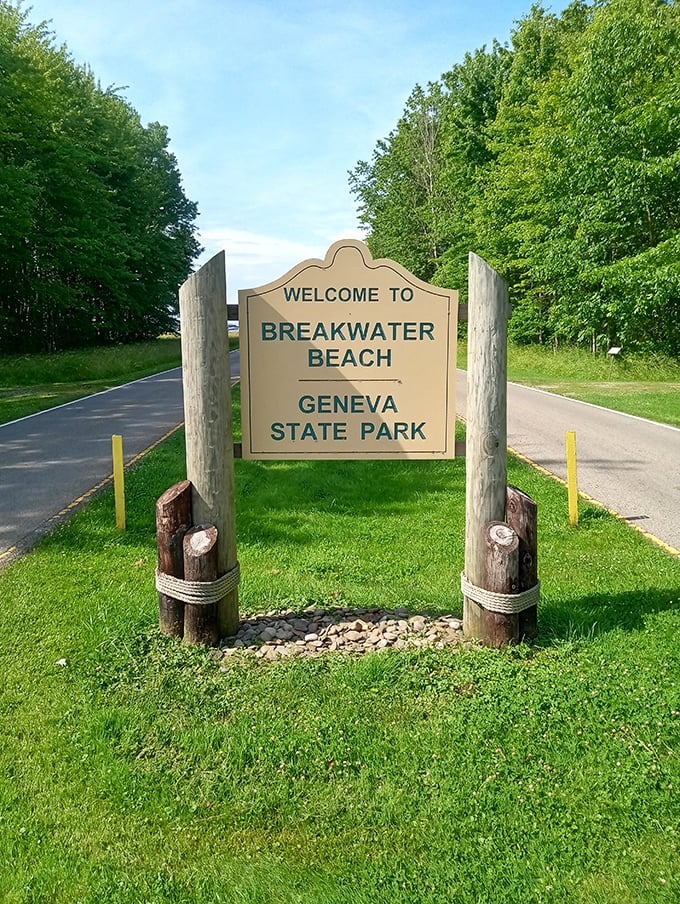The welcome sign stands as a friendly greeter, promising lake adventures and sandy memories just beyond its wooden frame.