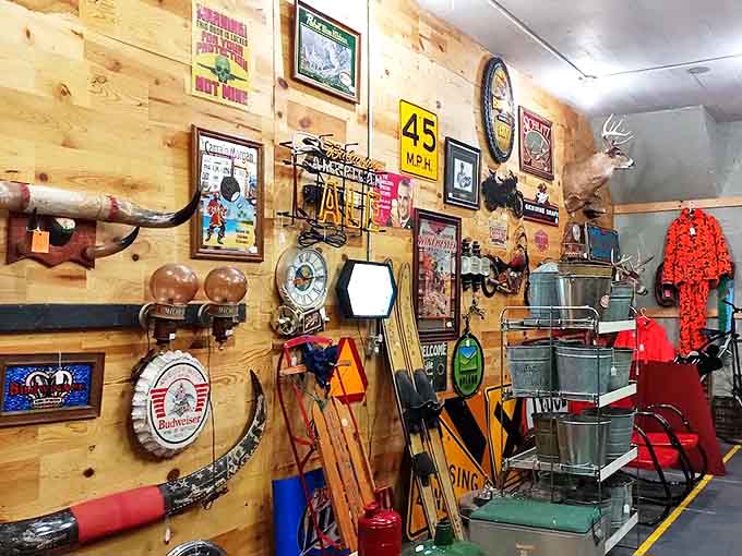 The man-cave corner where vintage sports equipment meets hunting memorabilia—testosterone-fueled nostalgia perfectly preserved under longhorn supervision.