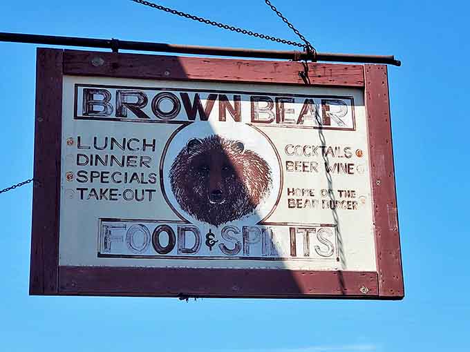 The vintage hanging sign featuring a dapper bear promises "Food & Spirits" with Midwestern straightforwardness. No false advertising here&mdash;just honest hospitality.