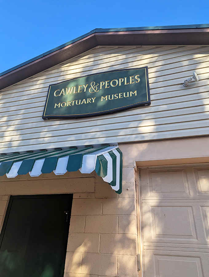 The Cawley & Peoples Mortuary Museum sign welcomes curious visitors to step inside and discover America's fascinating relationship with funeral traditions.