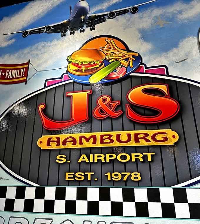 The wall art celebrates both food and flight, reminding diners that at J&S Hamburg, established in 1978, every meal is a journey worth taking.
