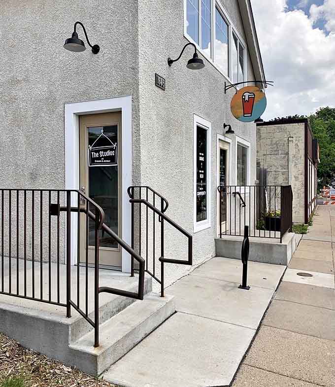 The threshold between ordinary life and literary escape, marked by a colorful sign promising good books, good beer, and good company.