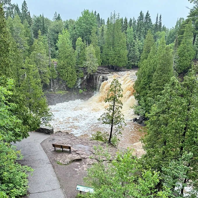 A thoughtfully placed bench invites hikers to pause and appreciate the waterfall's power &ndash; nature's version of front-row theater seating.