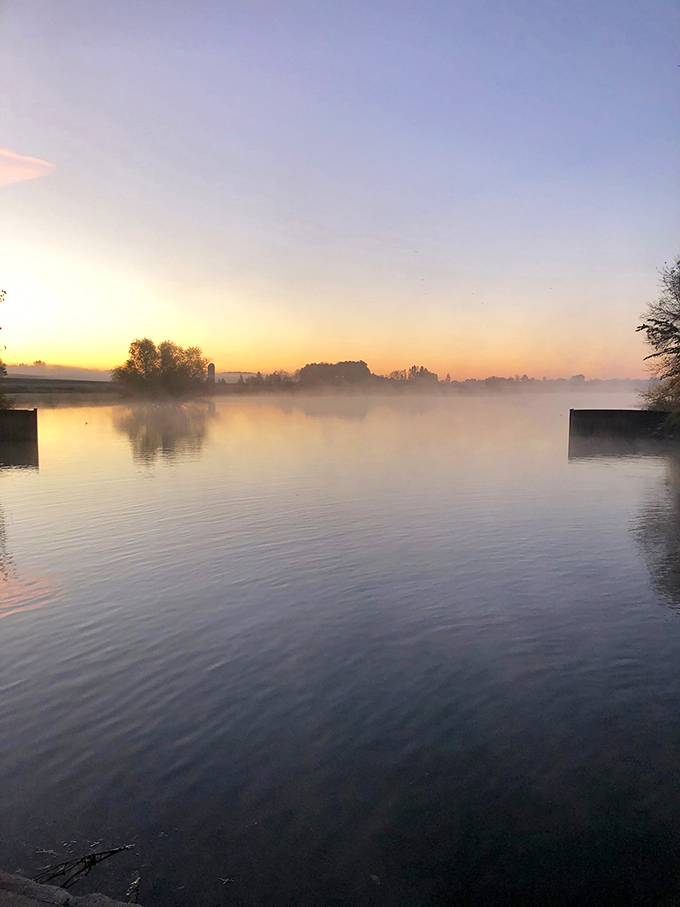 Dawn breaks over Deer Lake with ethereal mist rising from the water, creating a dreamscape worthy of a Minnesota postcard.