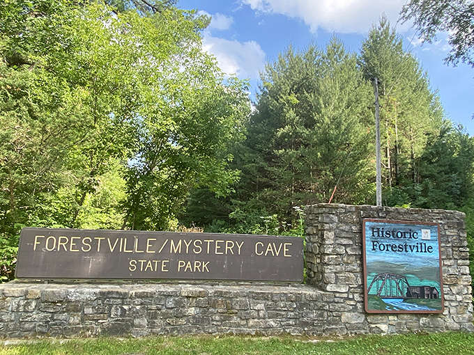 The park entrance sign welcomes visitors to both above-ground history and below-ground wonders, promising adventures vertical and horizontal.