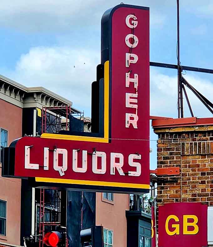 The vintage "GOPHER LIQUORS" sign glows against the Minnesota sky, a neon beacon guiding hungry pilgrims to coney dog paradise.