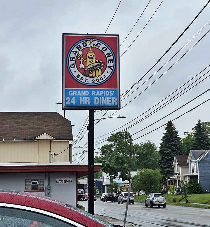 Grand Coney's roadside sign proudly announces "24 HR DINER," a promise that comfort food is available whenever life demands it.