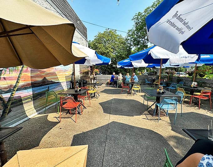 The outdoor patio features a rainbow of chairs under blue umbrellas &ndash; the perfect spot for people-watching with a side of Hi-Top heaven.