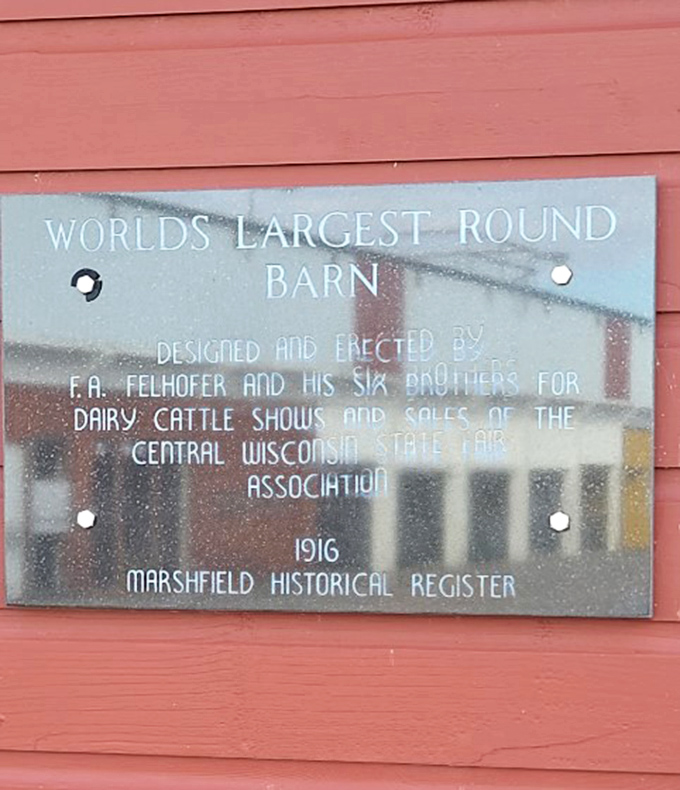 A historical plaque details the barn's 1916 origins, crediting the Felhofer family's vision for this architectural marvel that still stands today.