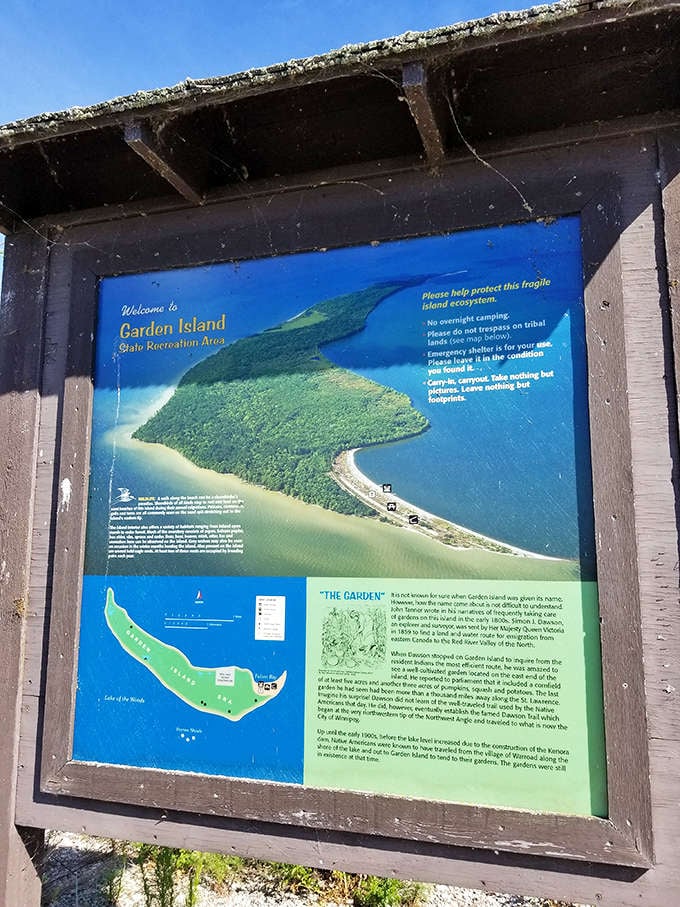 The weathered information board tells Garden Island's story, though the real narrative unfolds when you step beyond it.