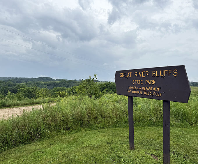 The unassuming park entrance sign stands like a humble doorway to natural wonders that rival anything on your social media feed.
