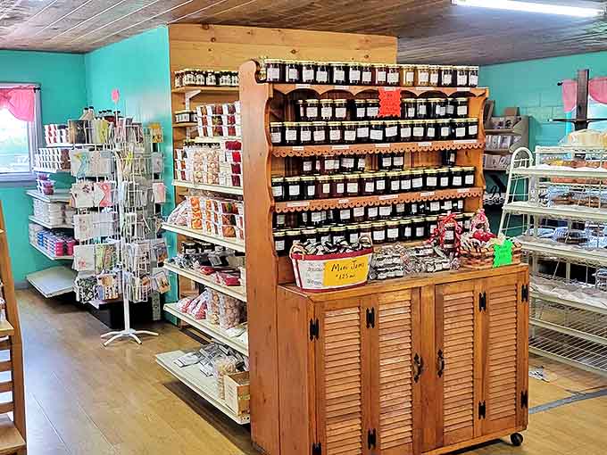 Jams, jellies and baking ingredients fill wooden shelves, turning this bakery into a one-stop shop for both ready-to-eat treats and pantry staples.