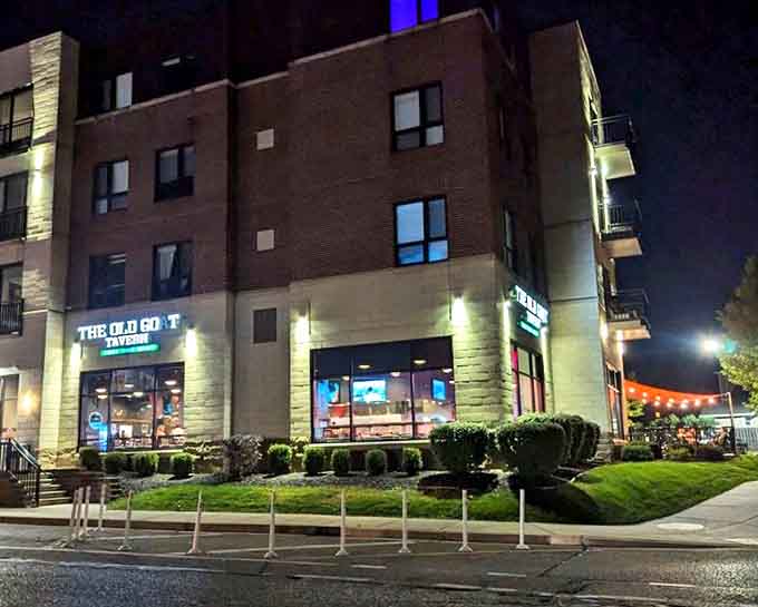 The Old Goat glows like a beacon of burger hope in the evening darkness, calling hungry souls home.