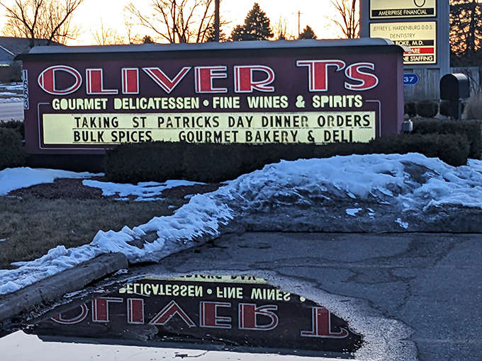 Even the roadside sign for Oliver T's hints at seasonal specialties and gourmet offerings that make this market a destination rather than just a stop.
