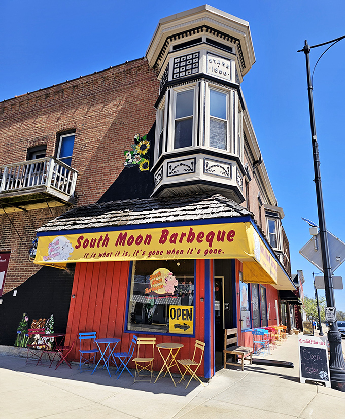 Cheerful outdoor seating with primary-colored tables creates an urban oasis where barbecue dreams come true under Illinois skies.