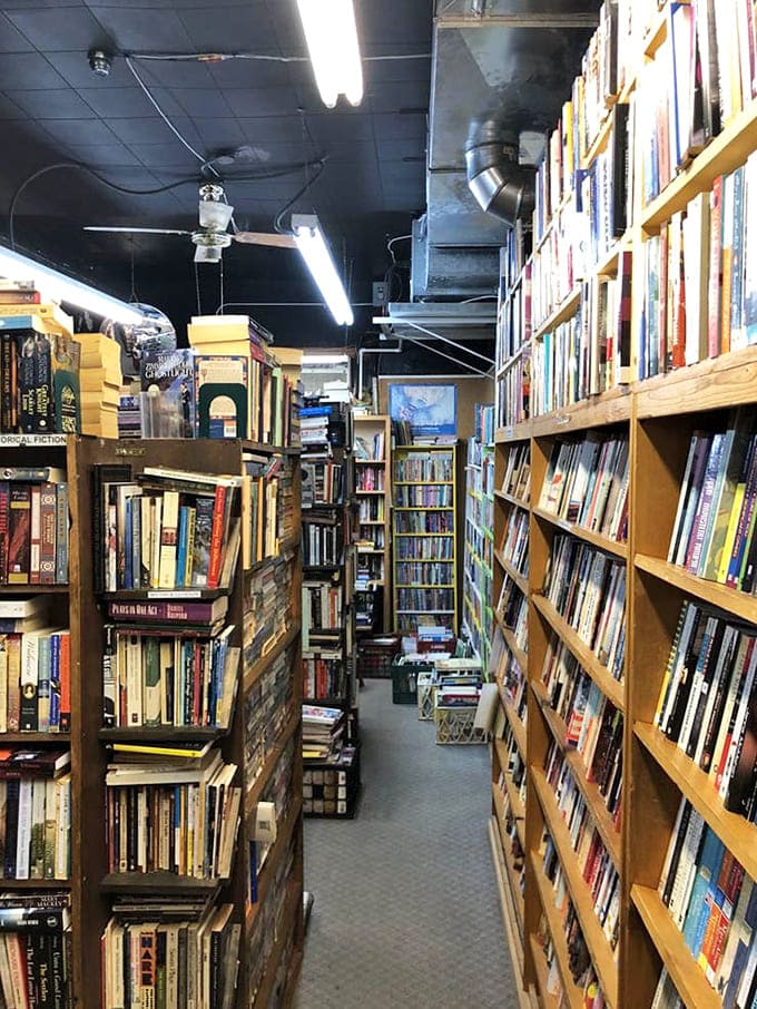 The industrial ceiling and warm lighting create the perfect ambiance for hours of browsing and discovering your next obsession.