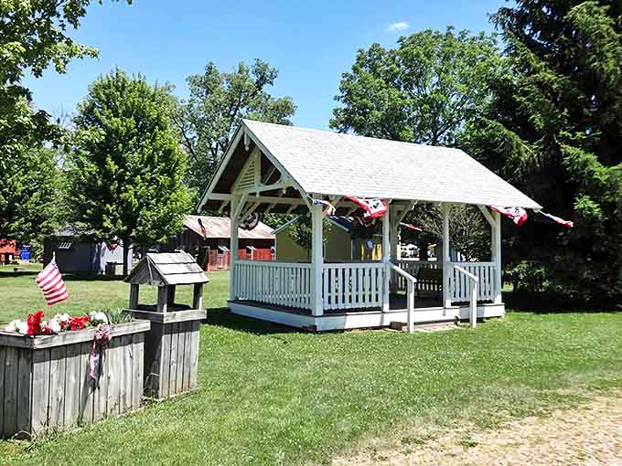 The village pavilion stands ready for gatherings, decorated with patriotic bunting that never goes out of style in Michigan.