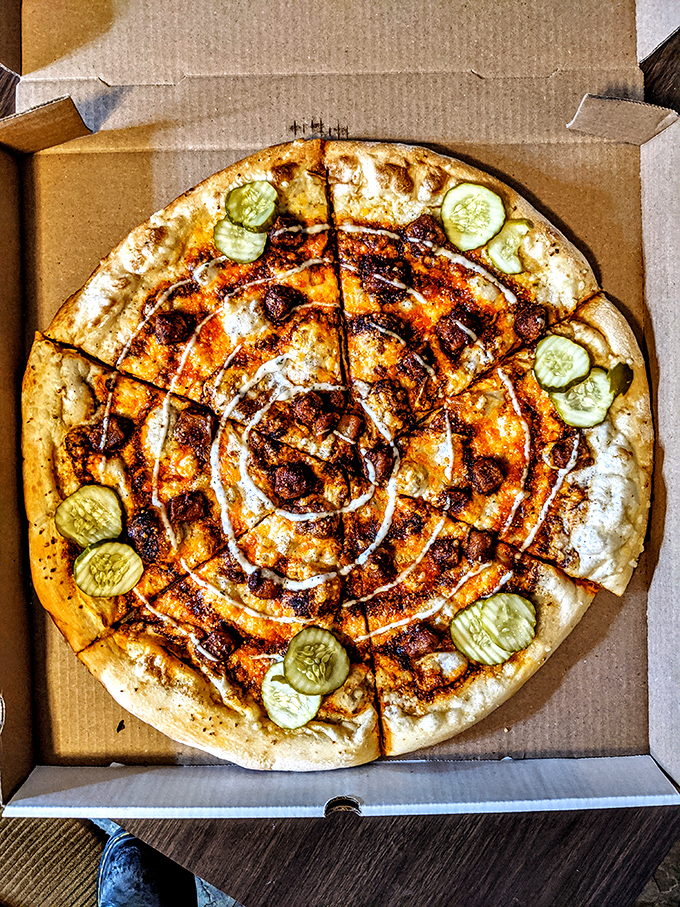 The pickle pizza defies skeptics with its perfect balance &ndash; cucumber slices dot a creamy white sauce canvas, creating an unexpectedly harmonious flavor symphony.