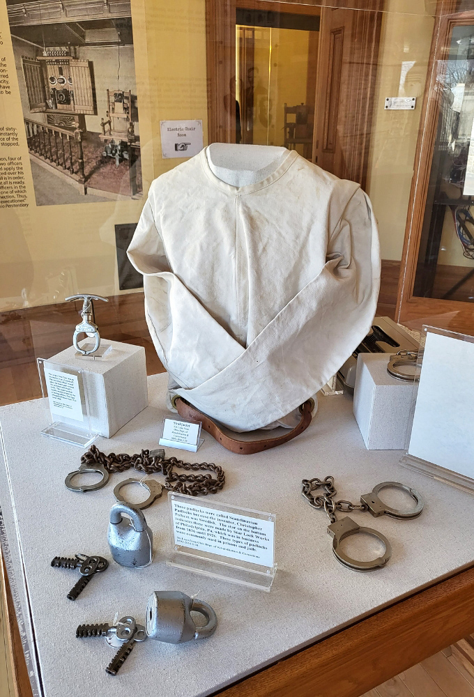 Chilling artifacts including a straitjacket and restraints reveal the harsher methods once used to maintain control within these stone walls.