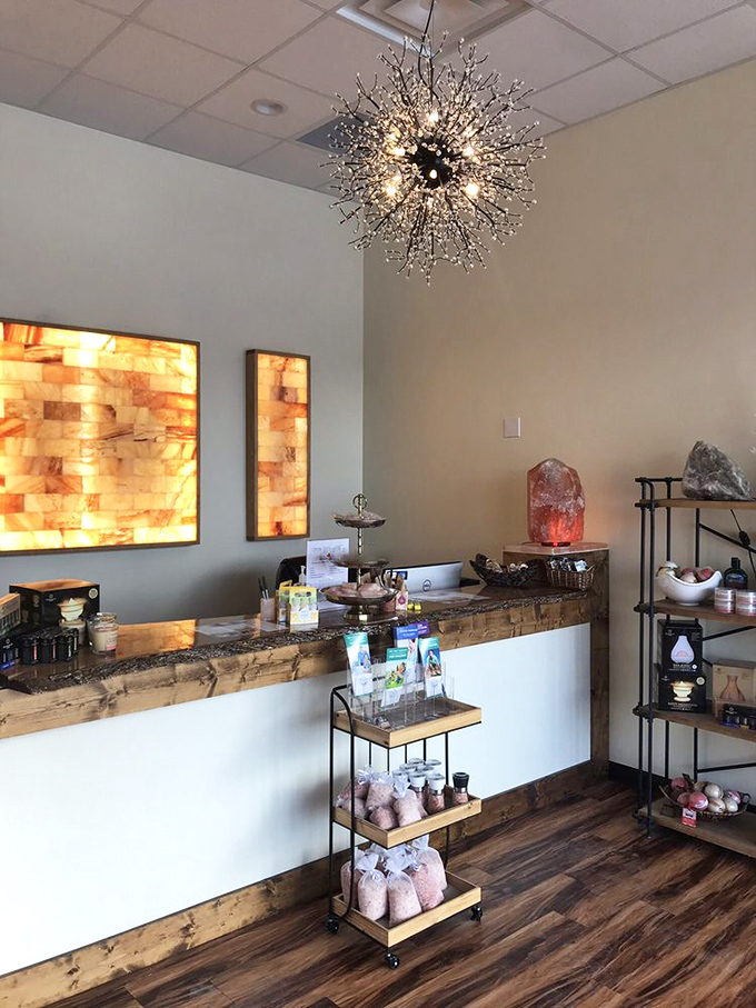 The welcoming reception area features illuminated salt panels and a sparkling chandelier that sets the tone for your visit.