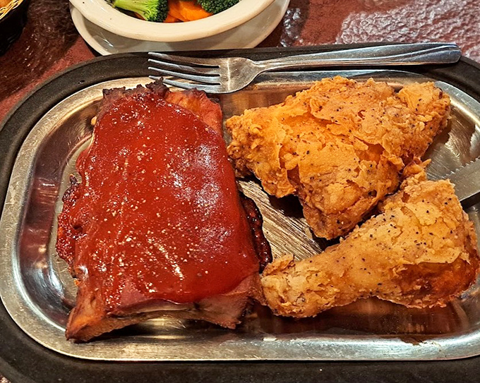 Baby back ribs glazed with tangy sauce alongside golden fried chicken &ndash; a combination plate that makes choosing unnecessary.