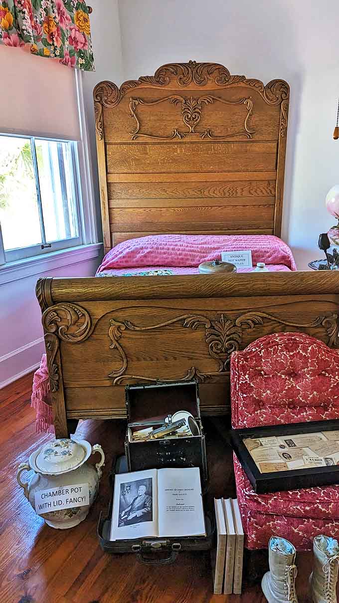 The master bedroom's ornate wooden bed frame and period furnishings create an intimate glimpse into private life a century ago.