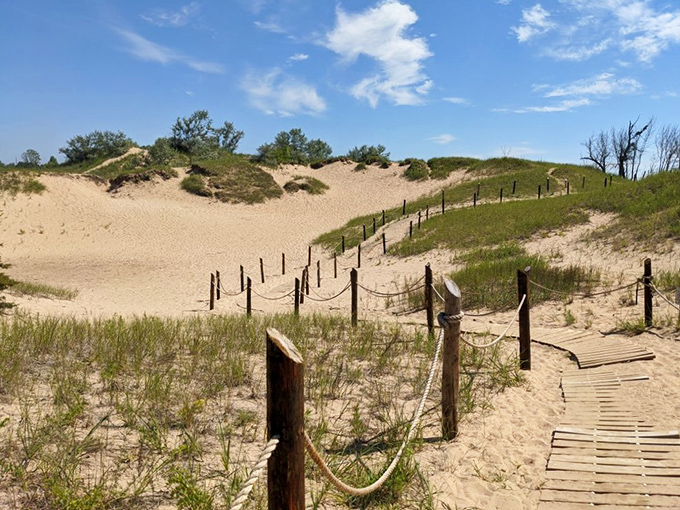 Summer adventurers follow the wooden trail, their silhouettes tiny against nature's grand canvas.