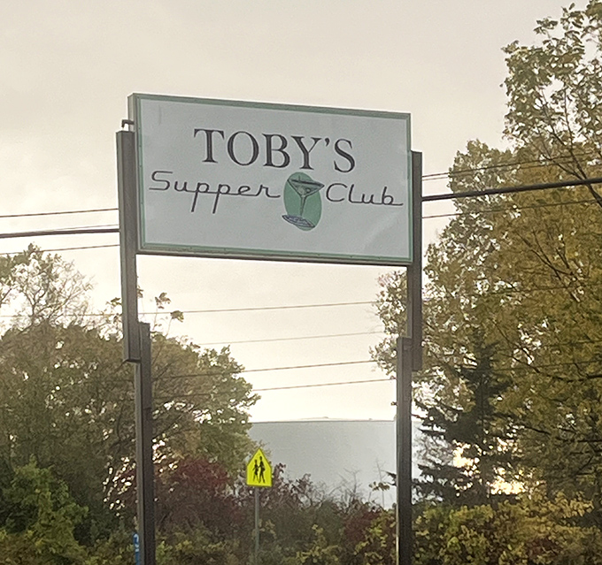 The iconic Toby's Supper Club sign stands tall against Wisconsin skies, a beacon for those seeking authentic dining experiences.