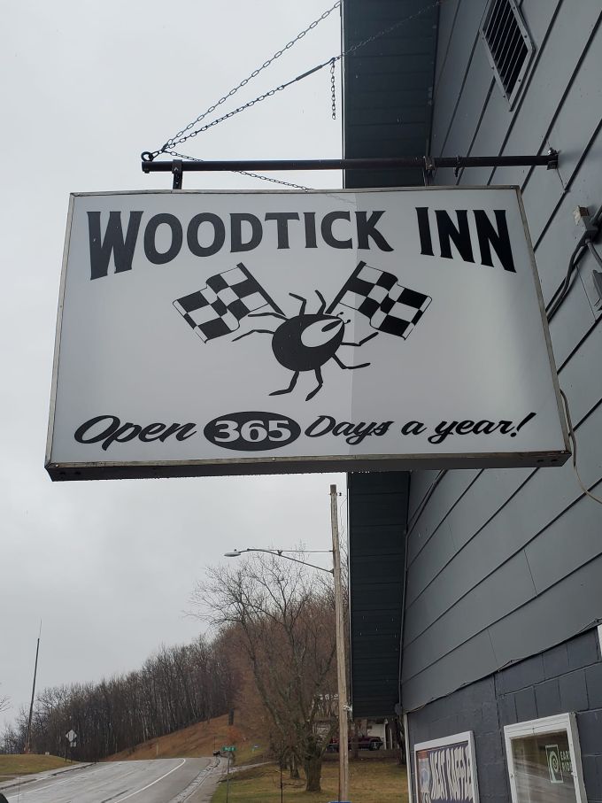 The classic "Woodtick Inn" sign promises fun 365 days a year. That racing checkered flag logo is waiting for a stop!