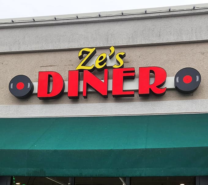Ze's iconic signage stands as a beacon for hungry travelers &ndash; red letters against beige that simply translate to "good food here."