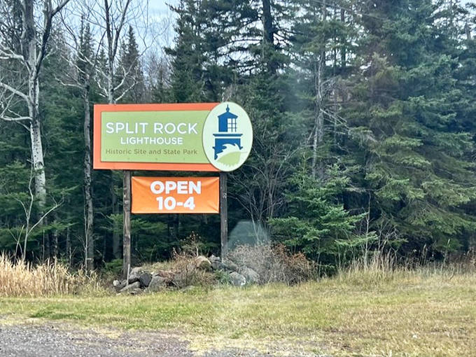 The park entrance sign promises adventure ahead, with operating hours that seem to say "lighthouse viewing is a daytime activity."