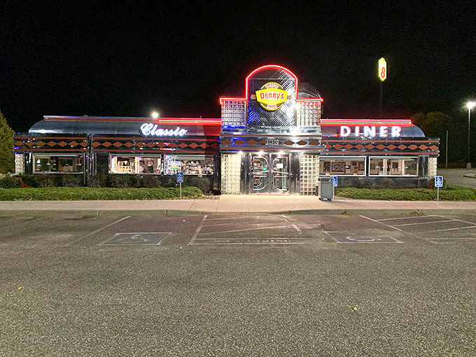 As night falls, Denny's neon glow transforms into something magical – a beacon of warmth and hospitality that draws hungry travelers like moths to flame.