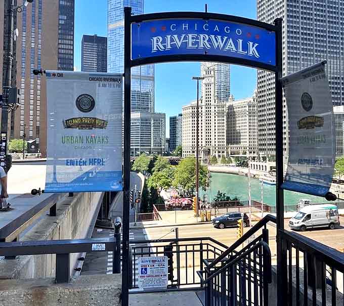 The welcoming Riverwalk entrance arch stands as a portal between everyday city life and the special waterfront world that awaits just steps below street level.