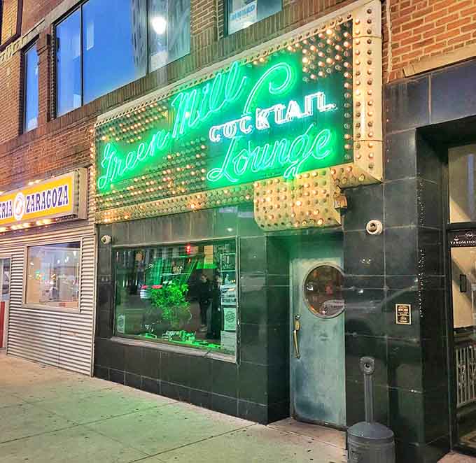 That unmistakable Green Mill glow transforms an ordinary street corner into the gateway to Chicago's most authentic jazz experience.