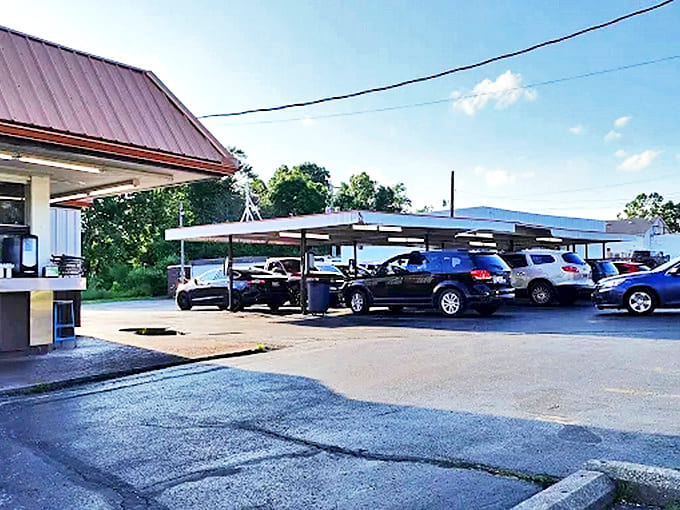 The parking lot transforms into a community gathering spot where motorcycles, minivans, and memories all find their place under the welcoming canopy.