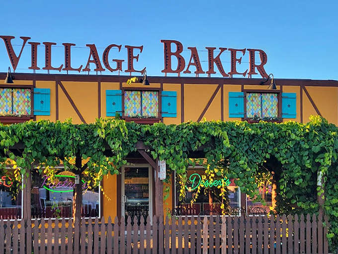 Vines climb the yellow facade beneath the iconic Village Baker sign &ndash; a beacon for carb-lovers and comfort-seekers throughout Michigan.
