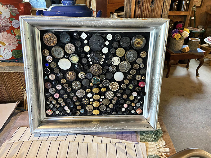 Someone's lifelong button collection, artfully arranged in this frame &ndash; each tiny disc representing a garment, a moment, a memory preserved.