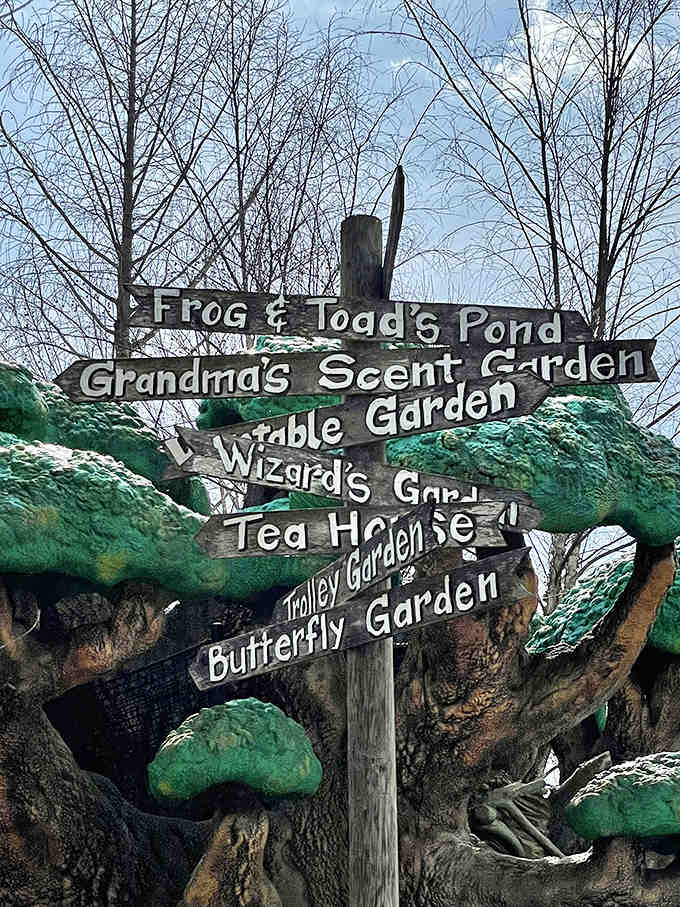 Which way to wonderland? These charming wooden signs point adventurers toward magical destinations throughout the garden's enchanted landscape.