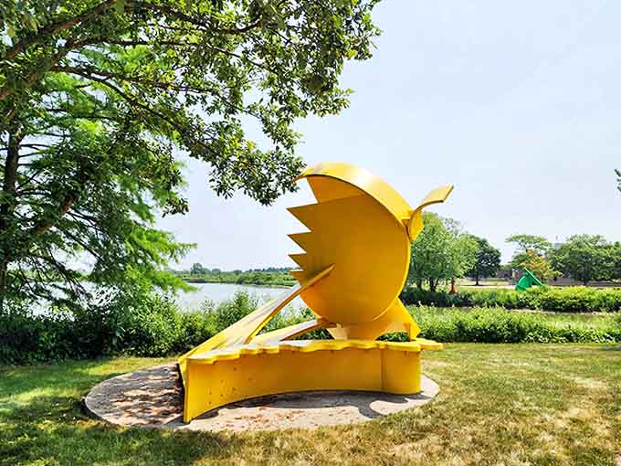 This sunshine-yellow creation resembles a mechanical bird frozen mid-screech, bringing playful energy to the serene landscape.