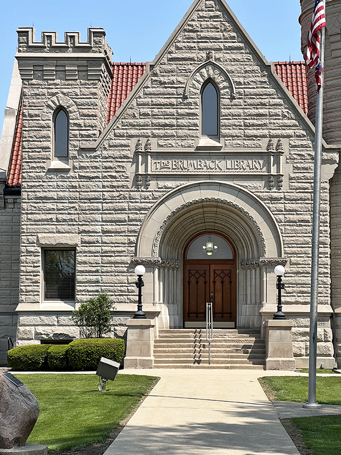 Summer sunlight bathes the Brumback's magnificent stone fa&ccedil;ade, highlighting architectural details that have made this library a beloved landmark for over a century.
