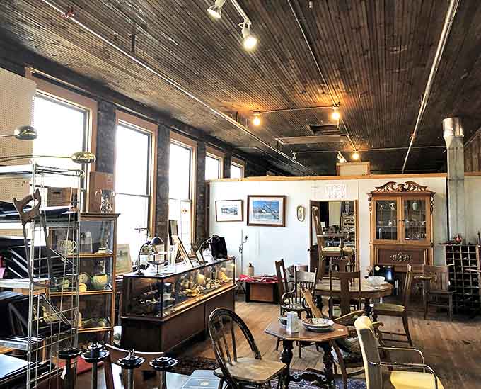 Sunlight streams through tall windows in this section, illuminating wooden furniture that has witnessed decades of family dinners and quiet conversations.