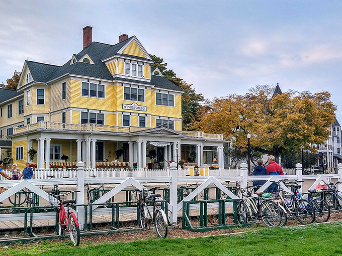 The Windermere's exterior glows golden in the sunlight, its white picket fence and bicycle rack epitomizing island charm.