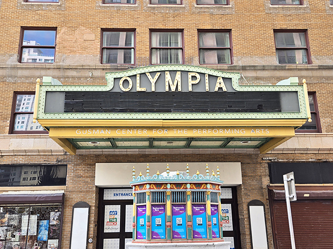 The iconic Olympia marquee stands as downtown Miami's cultural lighthouse, beckoning passersby into a world where Netflix has nothing on real-life magic.