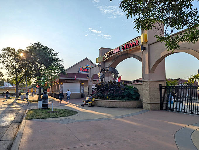 Morning light bathes the International Bazaar entrance in golden hues, promising a day of cultural adventures for early birds seeking global treasures.