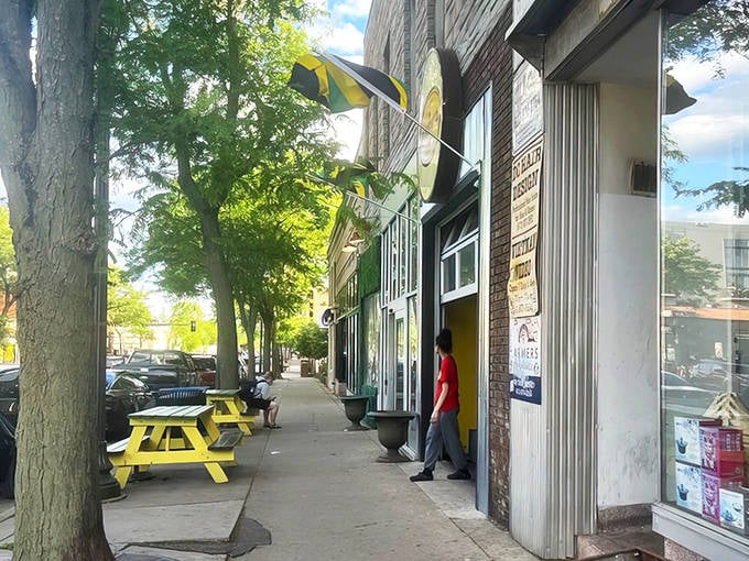 The sidewalk view &ndash; a yellow picnic table invites outdoor dining when Minnesota's weather decides to cooperate with your Caribbean food cravings.