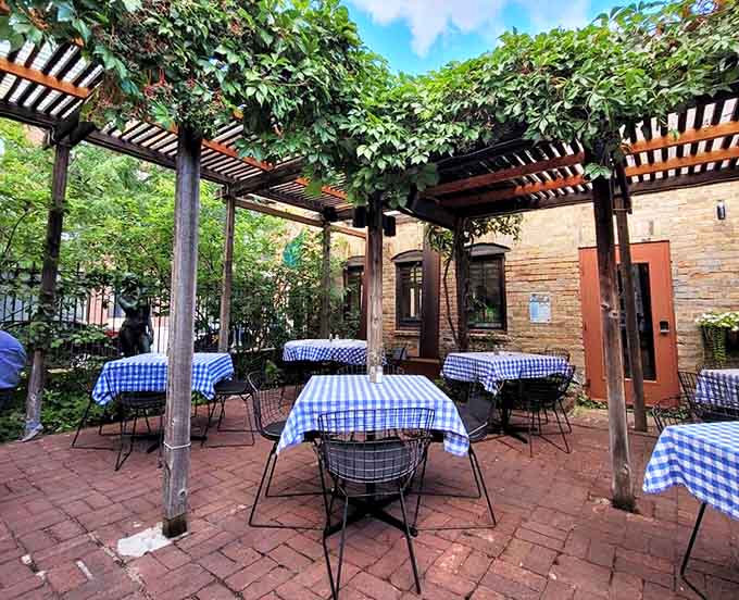 Dappled sunlight filters through pergolas draped with greenery, creating a secret garden atmosphere perfect for enjoying a leisurely German feast.