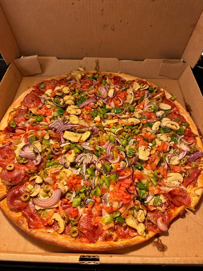 A supreme pizza showcases the Mansfield philosophy that more is more when it comes to toppings, creating a colorful mosaic of flavors in every bite.